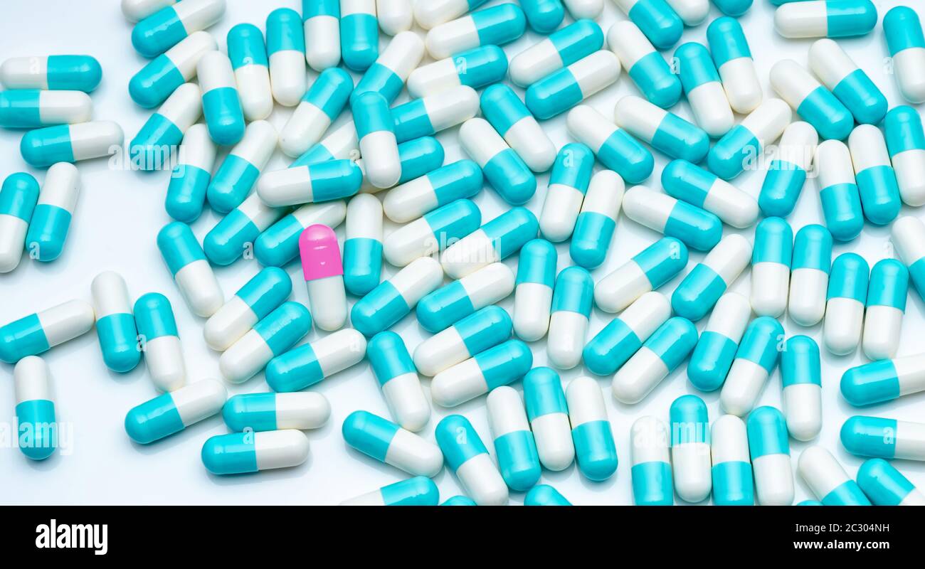 Pink-white capsule pill outstanding in crowd of blue-white capsule ...