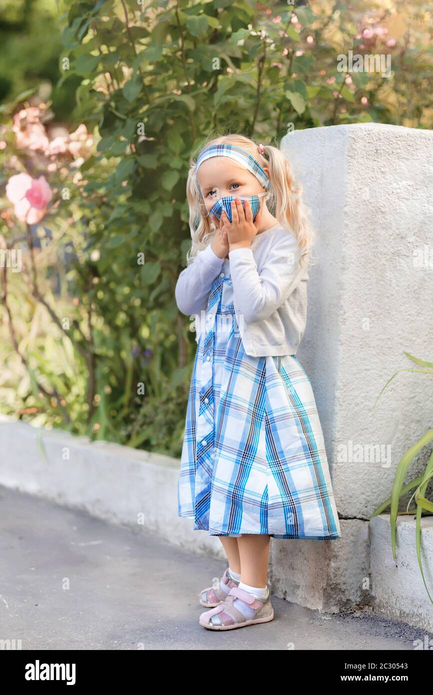 Little girl in a protective mask Stock Photo - Alamy