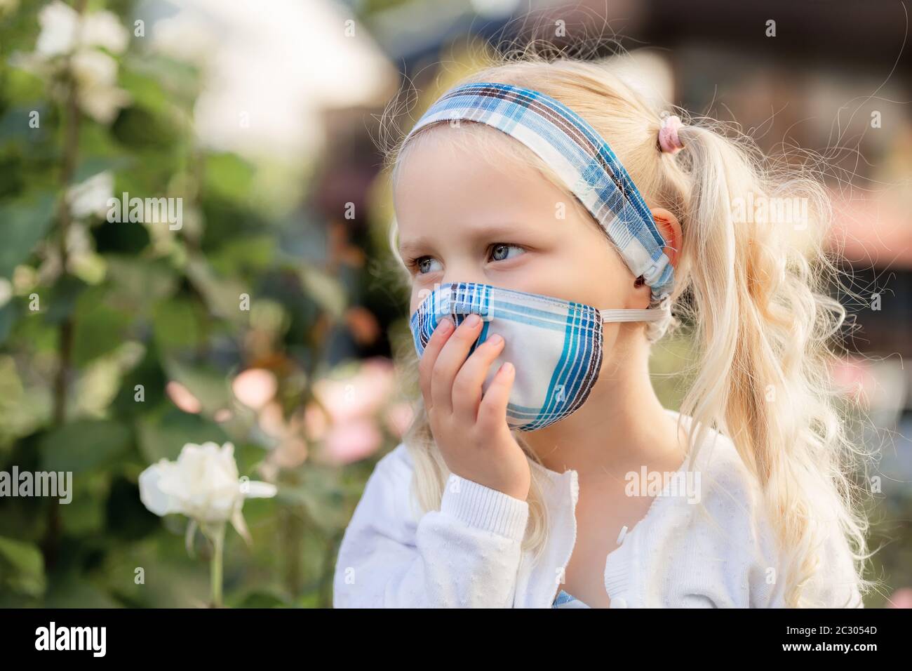 Little girl in a protective mask Stock Photo - Alamy