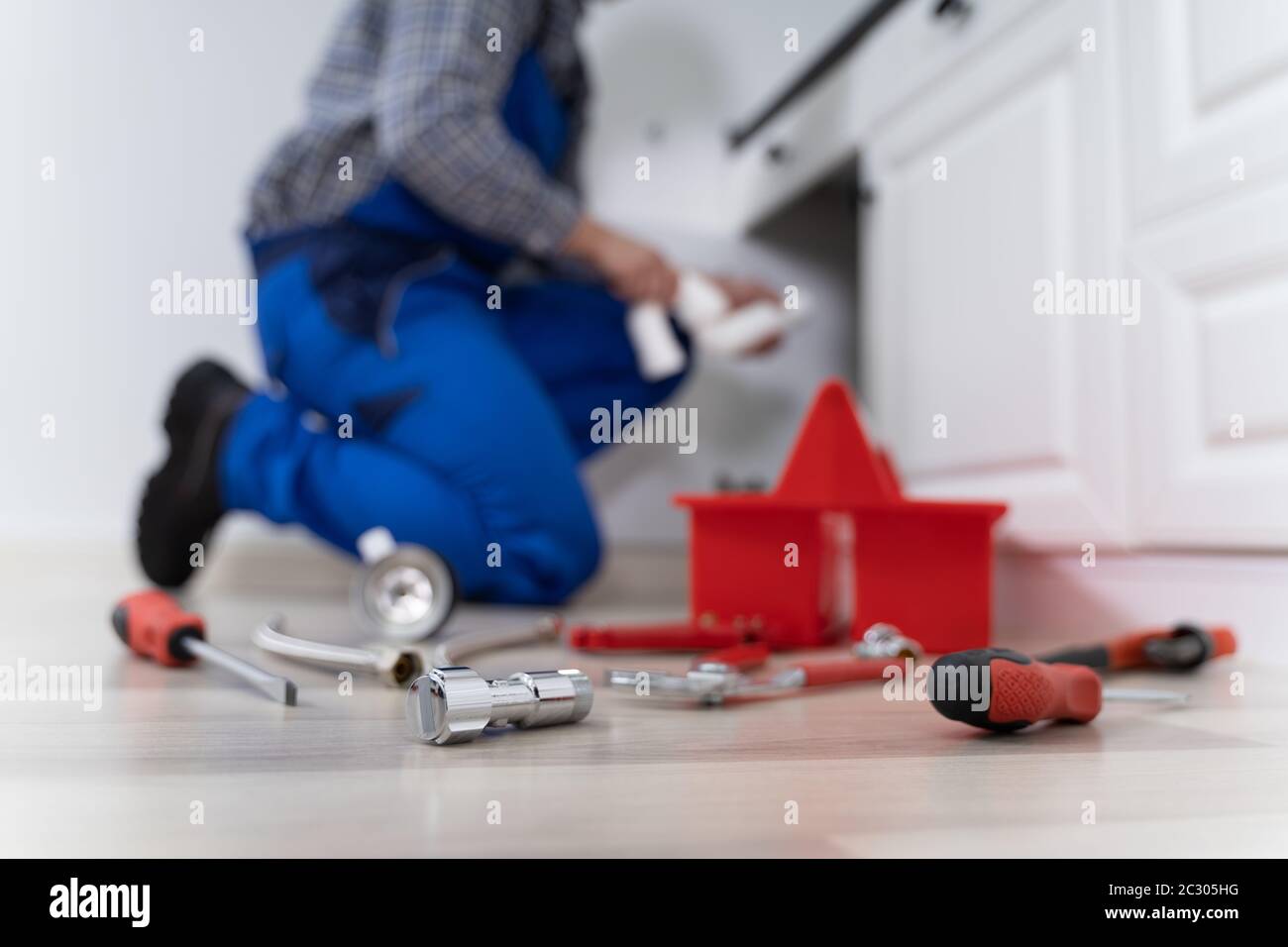 Male Plumber In Overall Fixing Kitchen Sink Pipe Stock Photo - Alamy