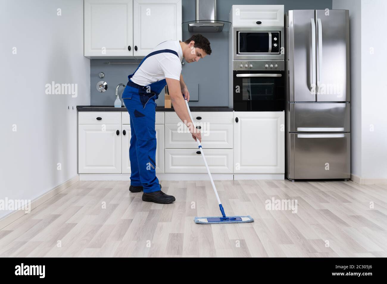 Man cleaning oven in hi-res stock photography and images - Alamy