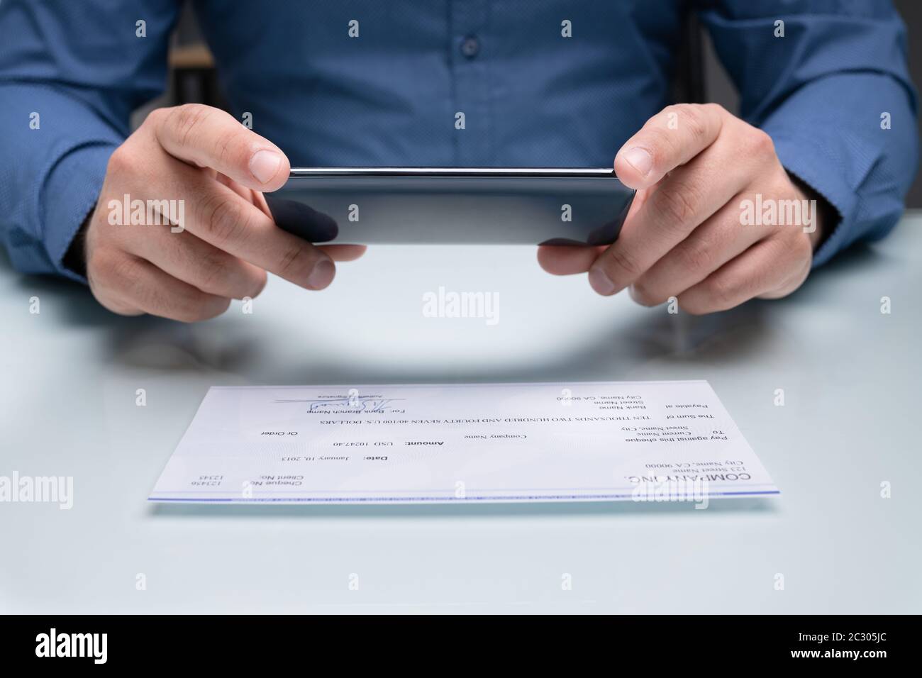 Man Taking Photo Of Cheque To Make Remote Deposit In Bank Stock Photo ...