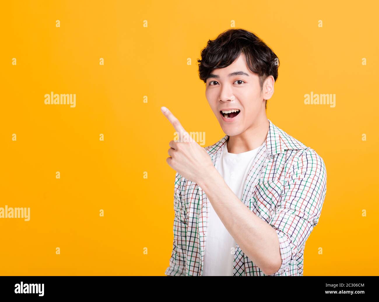 happy young man hand pointing to something Stock Photo - Alamy