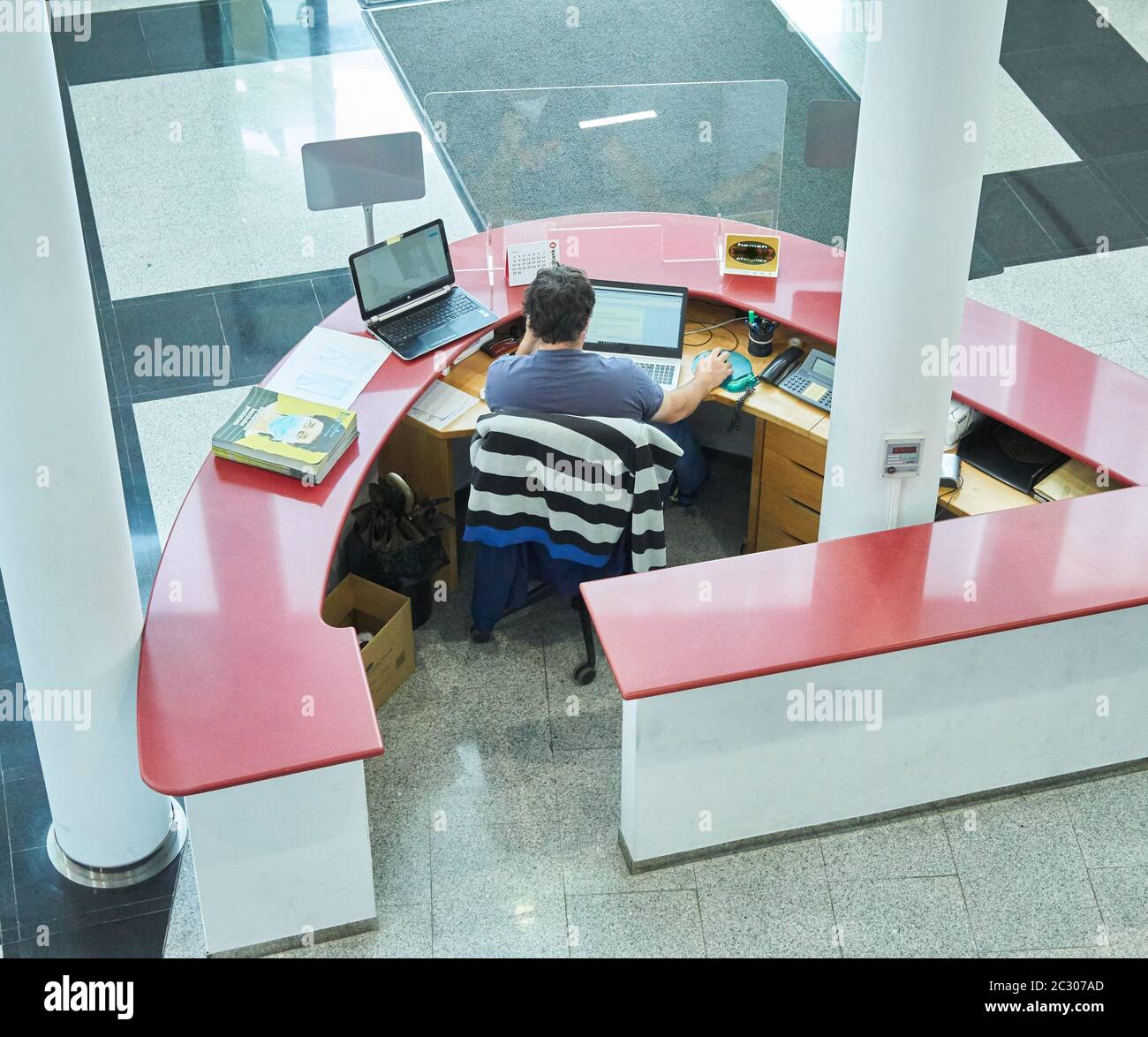 An hotel receptionist working in holiday. Reservation concept Stock ...