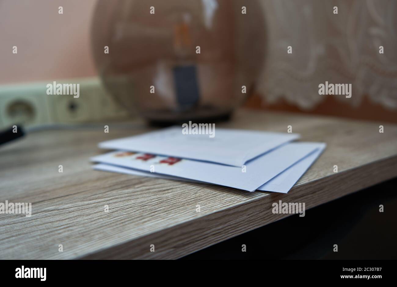 Envelopes on the table with lamp Stock Photo - Alamy