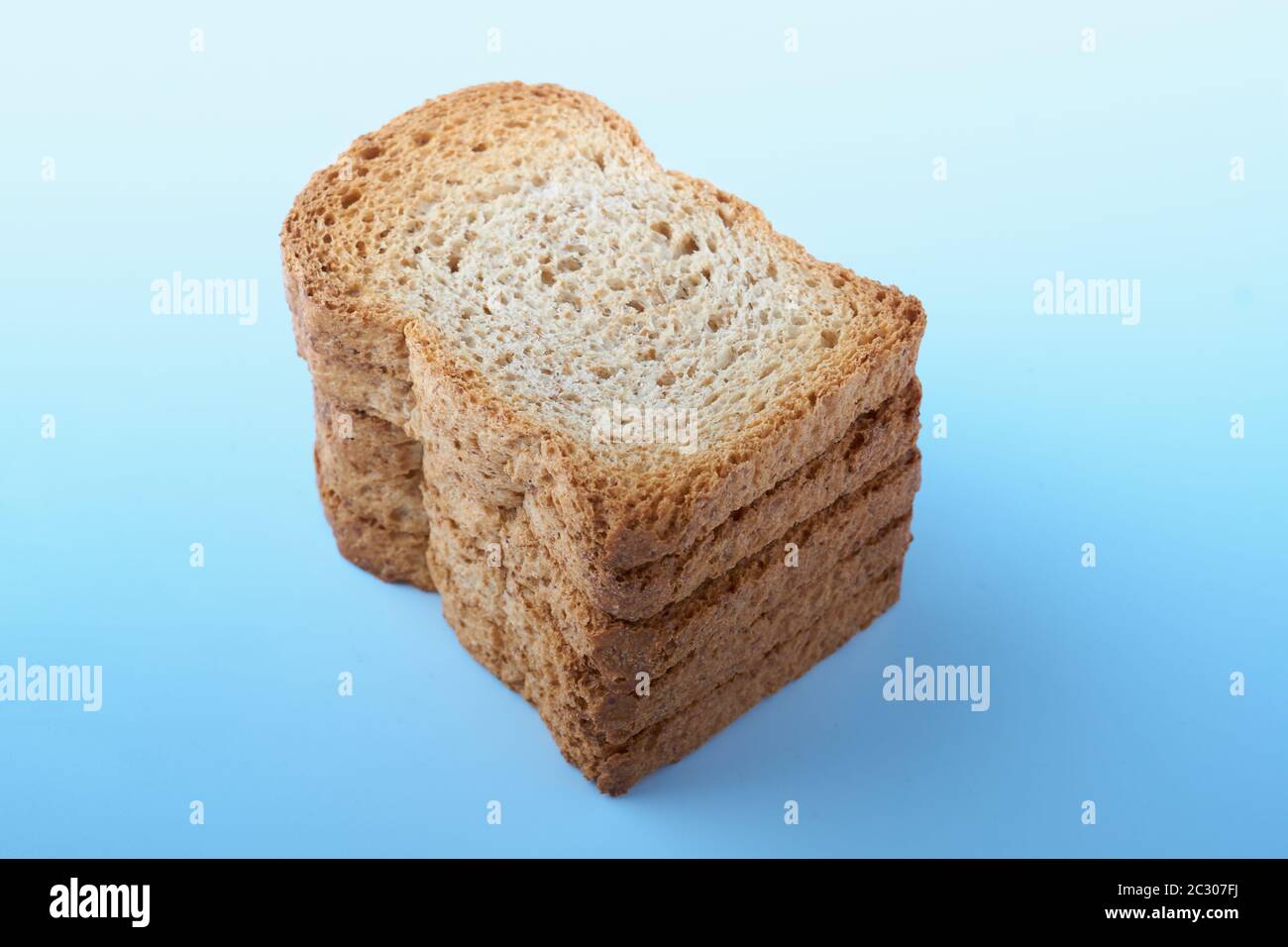 Four toast in a pile isolated on blue background Stock Photo - Alamy
