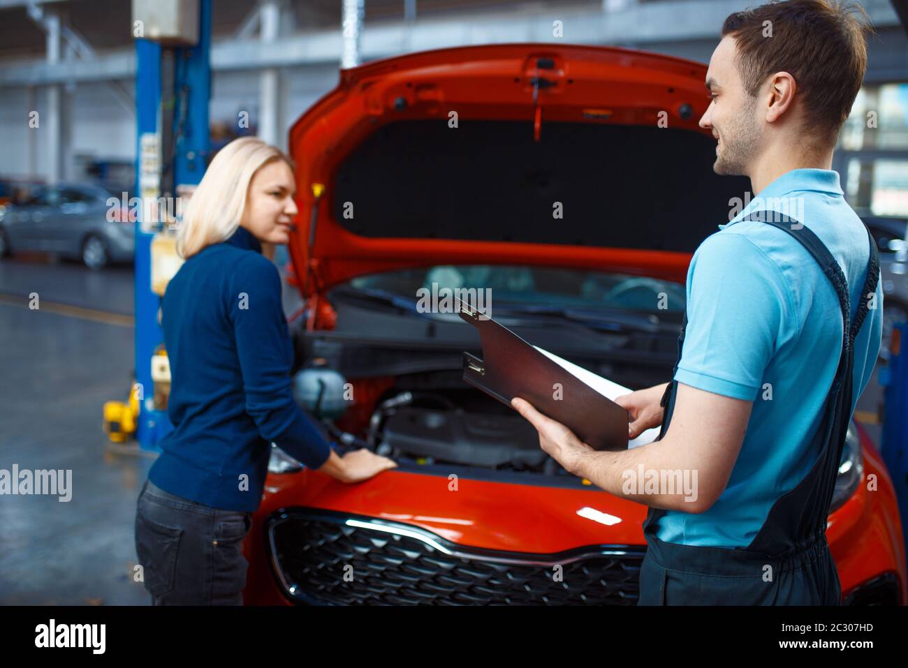 Woman and worker with checklist, car service. Female client on auto ...