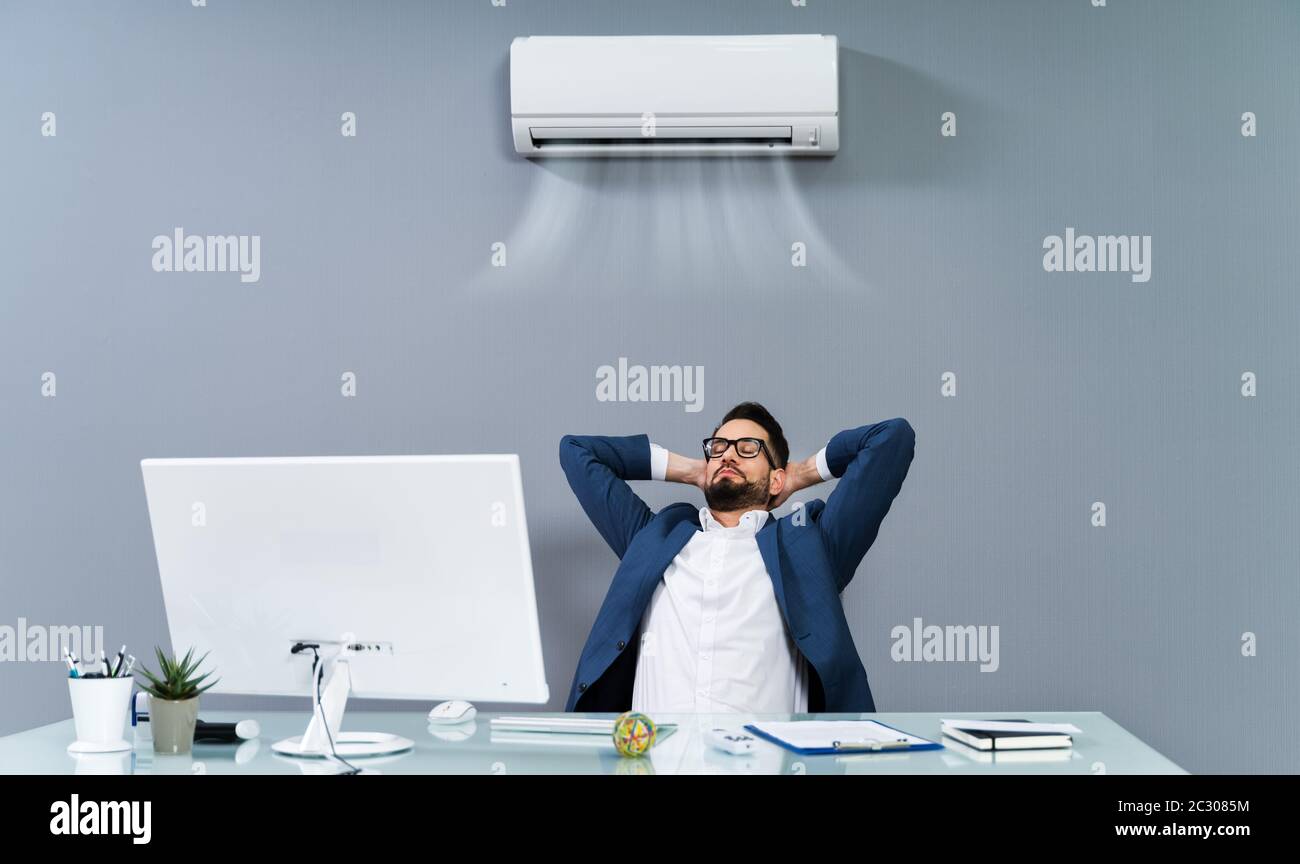 Relaxed Businessman Enjoying The Cooling Of Air Conditioner In The ...