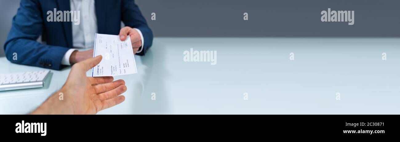 Close-up Of A Business Man Giving Cheque To His Colleague At Workplace ...