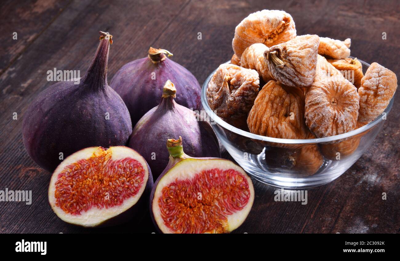 Composition with fresh and dried figs on wooden table Stock Photo - Alamy