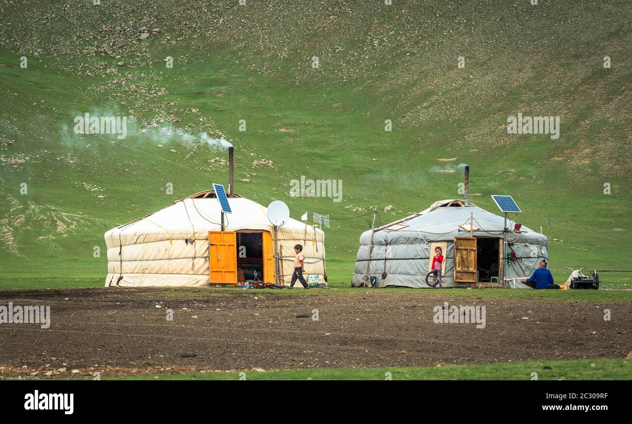 Nomadic yurts, summer, children at the door, smoke from chimneys ...