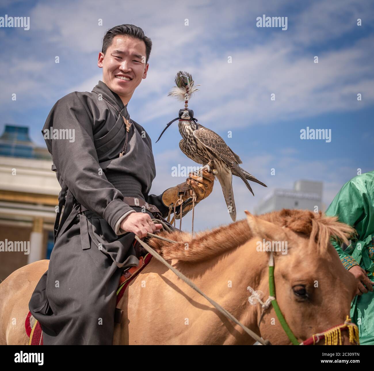Young hunter with trained falcon on the horse, Ulaanbaatar city ...