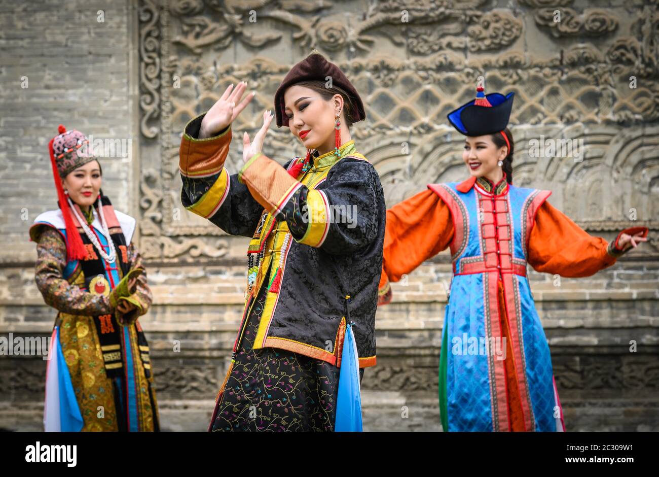 Dancing girls in the traditional costumes in front of Buddhist ...