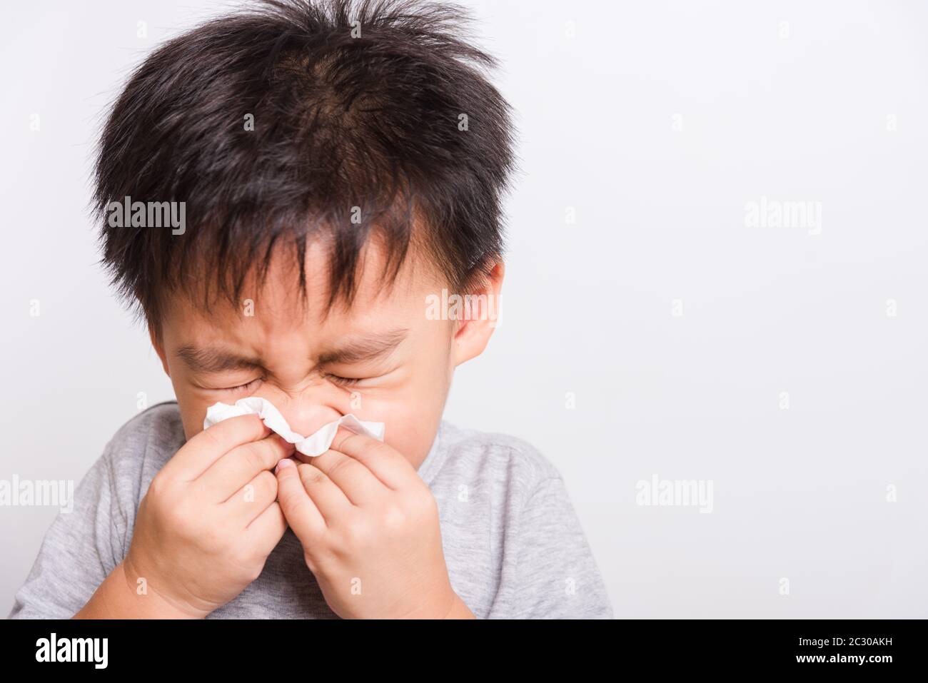 Closeup Asian face, Little children boy cleaning nose with tissue on ...