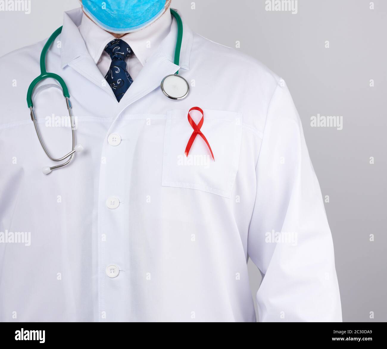doctor in a white coat and tie is standing on a white background, red ...