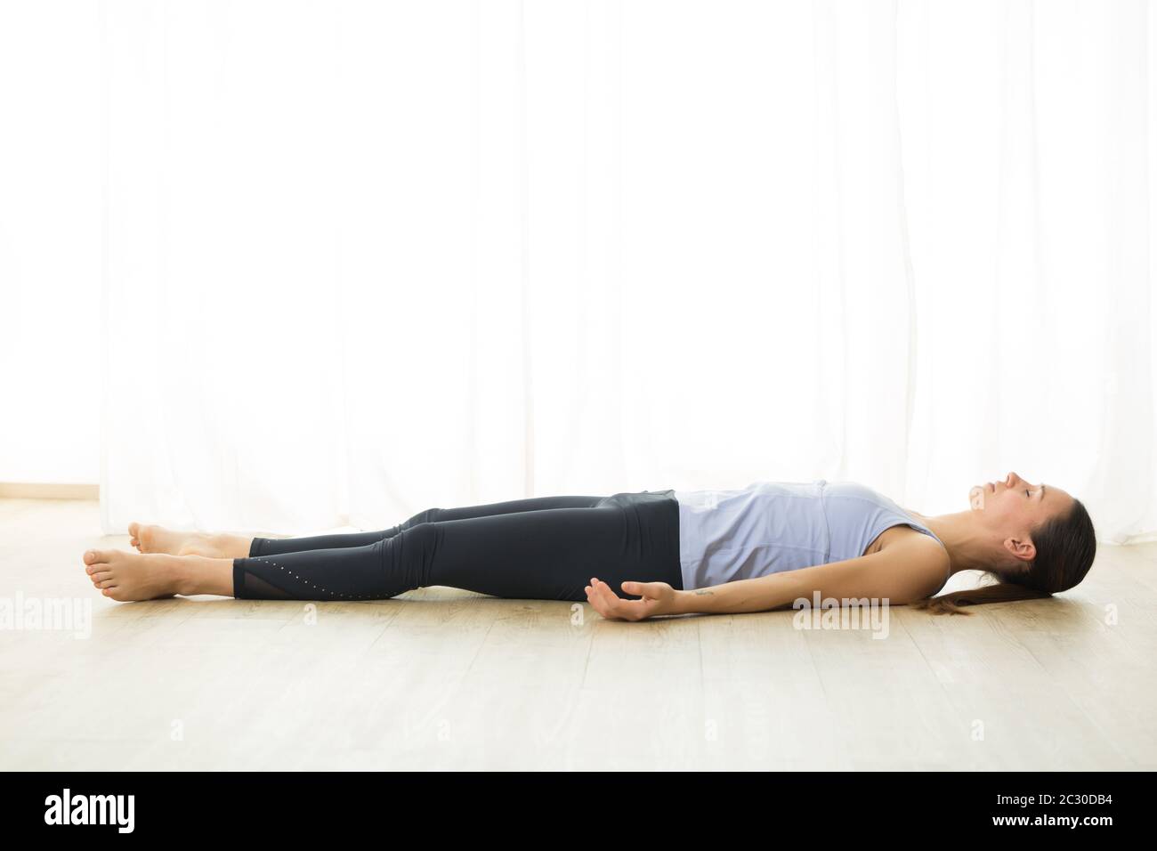 Portrait of gorgeous active sporty young woman practicing yoga in studio. Beautiful girl ...