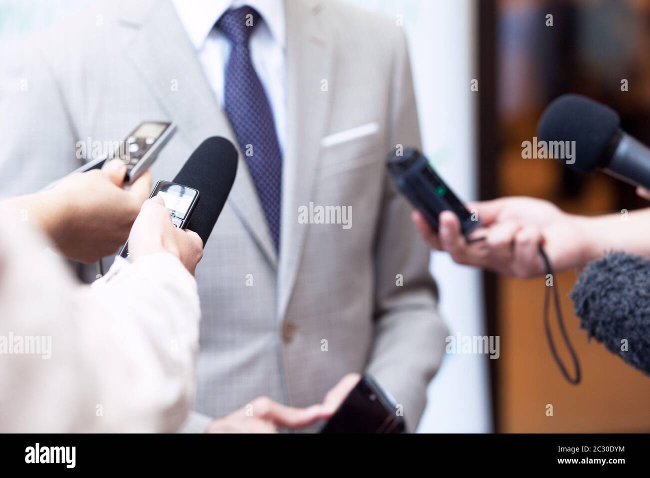 Reporters making media interview with unrecognizable businessman or ...