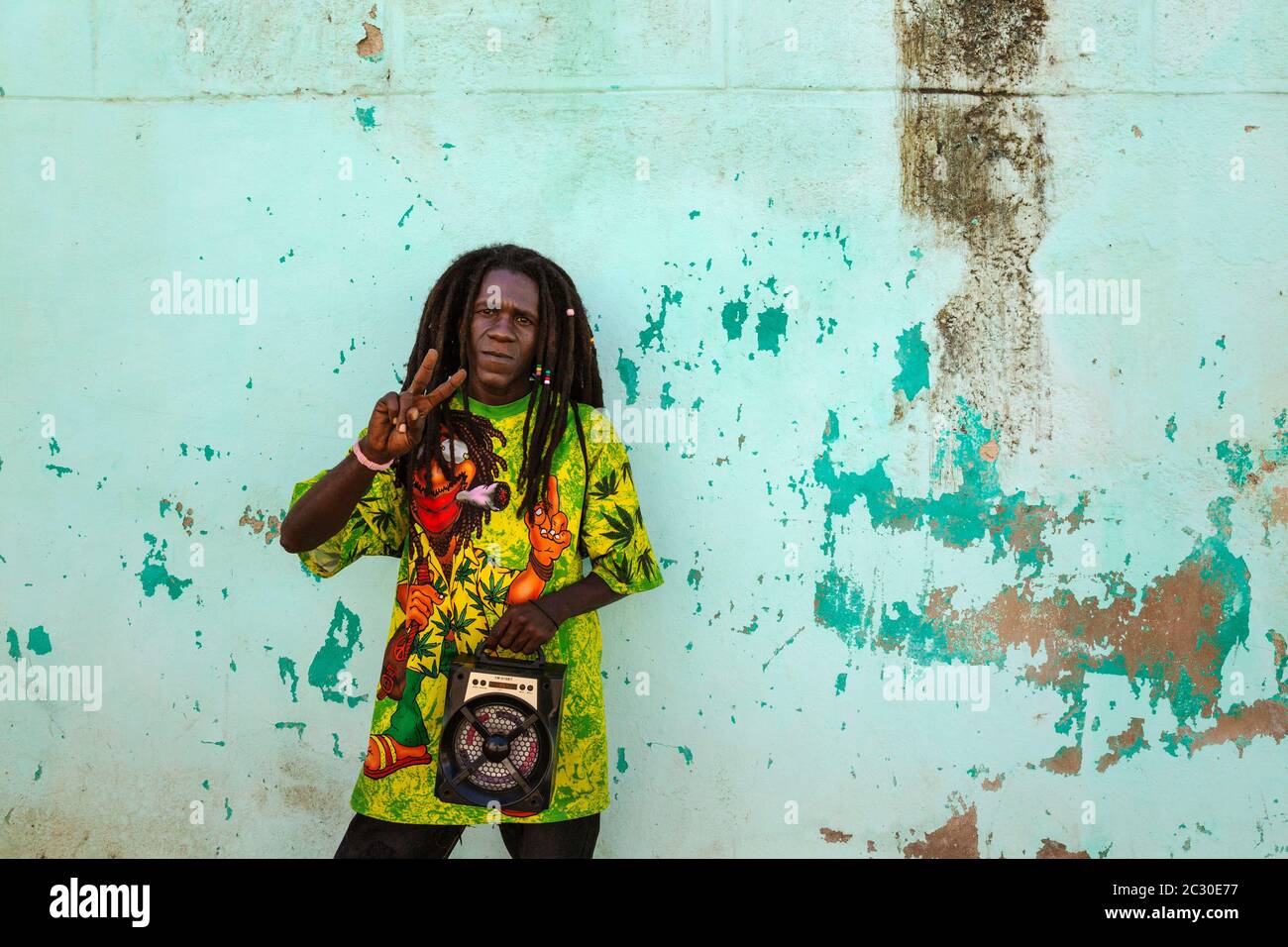 Rasta at a decayed wall of crumbling plaster, Santiago de Cuba, Cuba ...