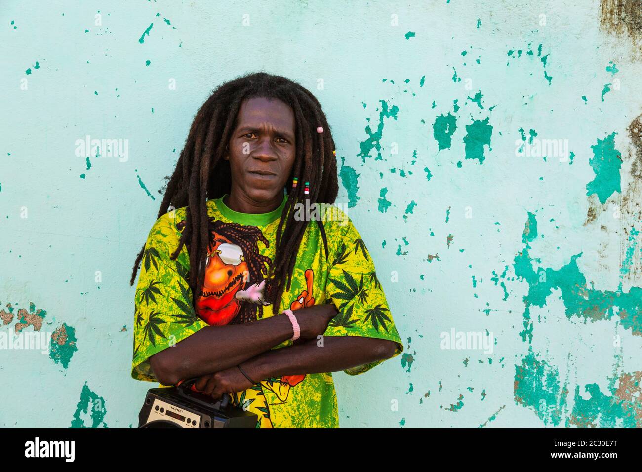 Rasta at a decayed wall of crumbling plaster hi-res stock photography ...