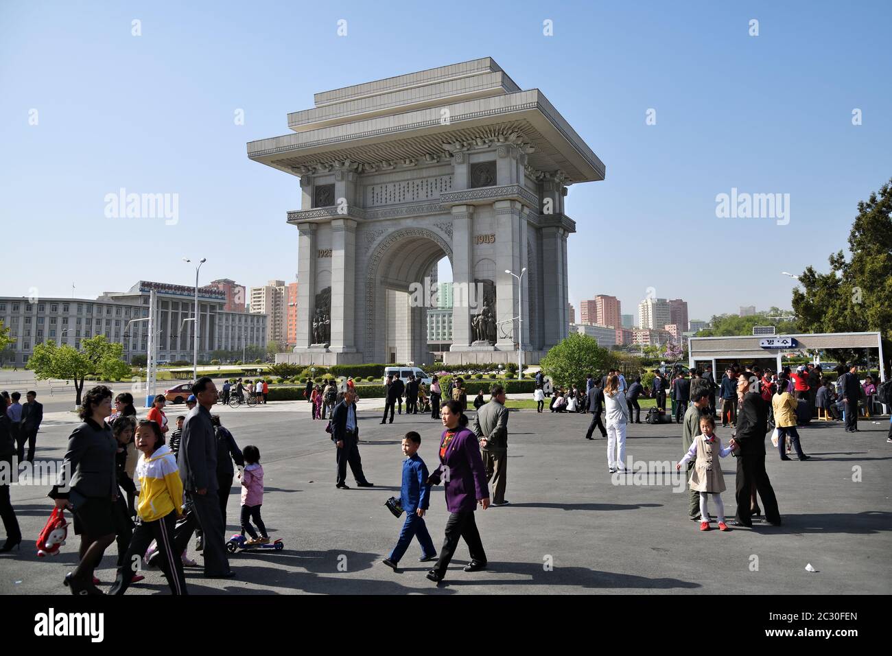 Pyongyang, North Korea - May 1, 2019: People in the square next to Arch ...