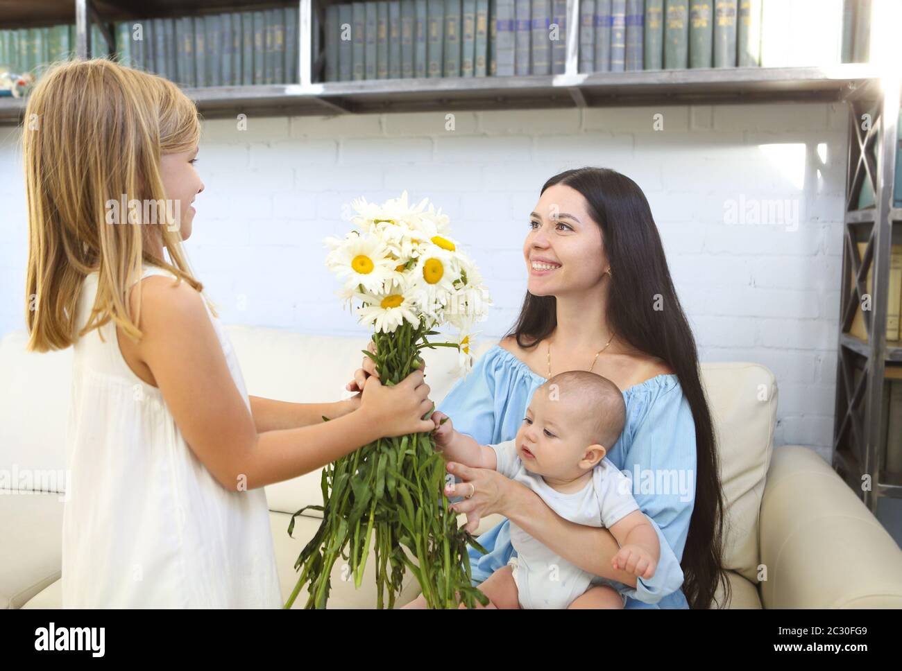 Little girl giving bouquet of beautiful flowers to her mother Stock ...