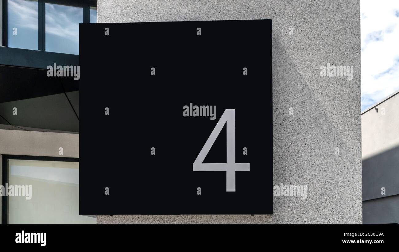 Number Four with black background on a facade Stock Photo - Alamy