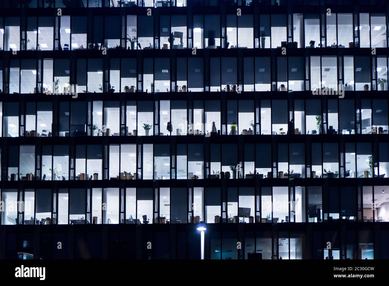 Office Building At Night. Late night at work. Glass curtain wall office ...