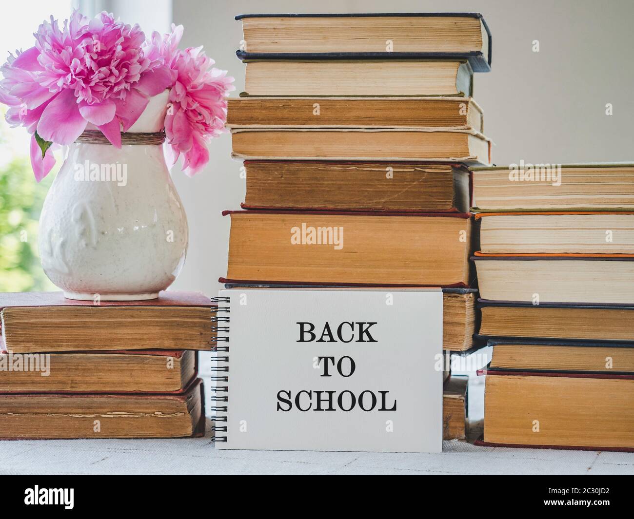 Stack of vintage books and beautiful flowers Stock Photo - Alamy