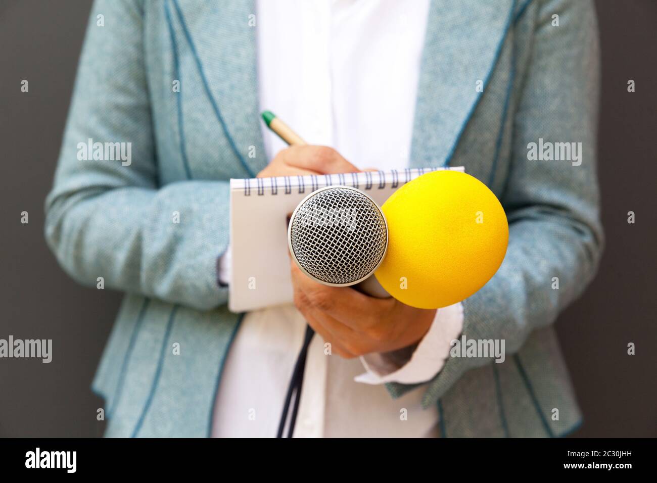 Female reporter at press conference Stock Photo - Alamy