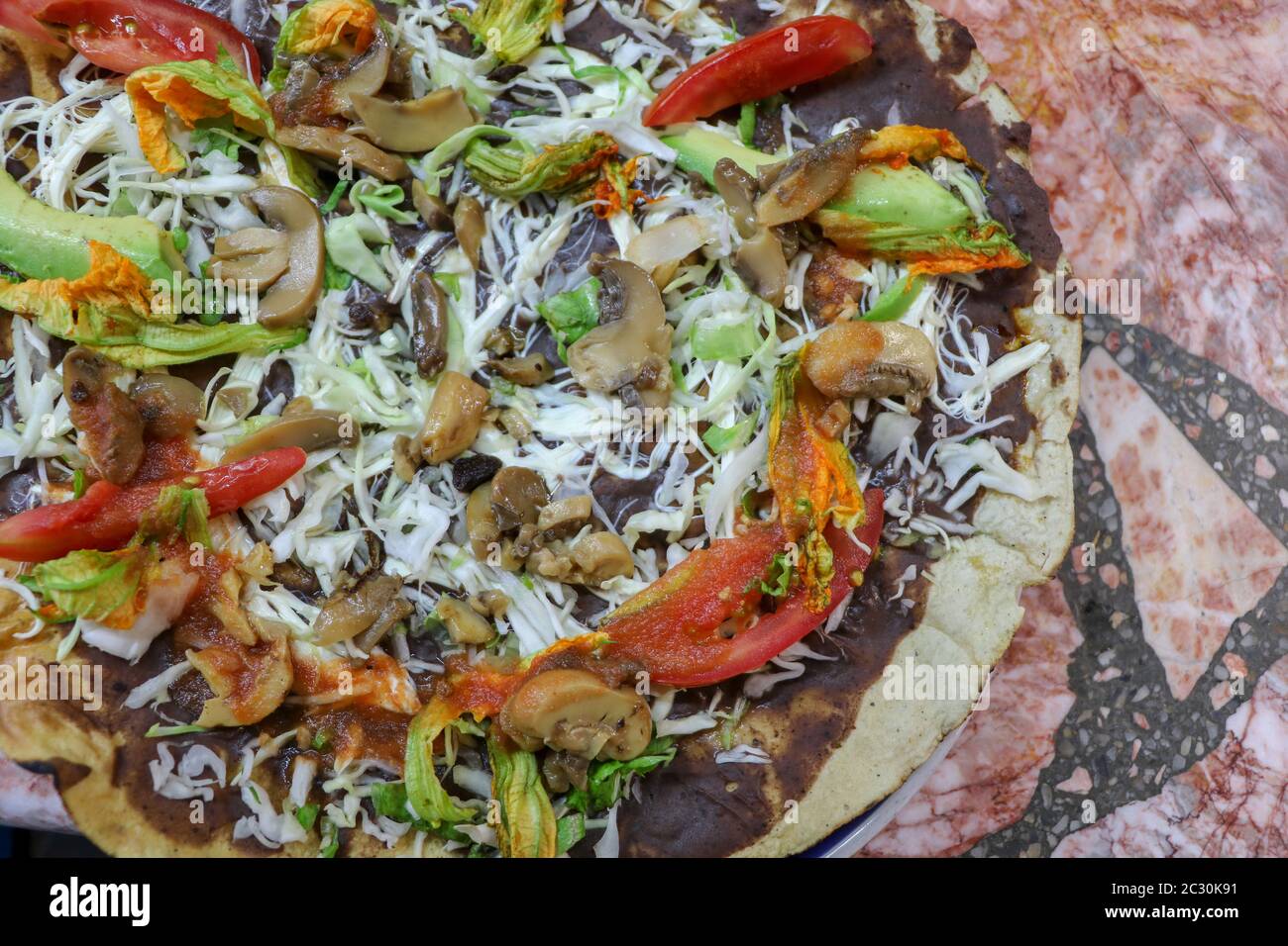 This is a tlayuda, a very traditional dish of Oaxaca in the south part ...