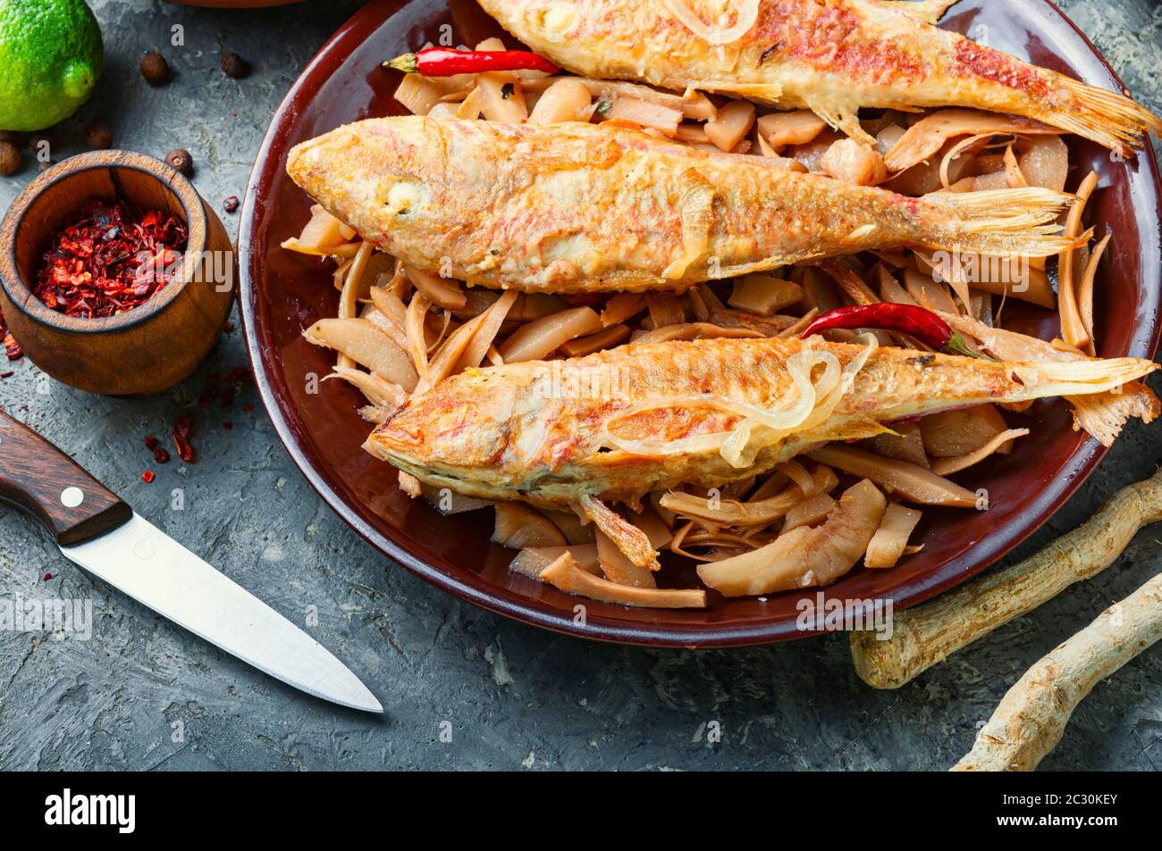 Mullet fish fried with horseradish roots.Tasty and spicy fry fish Stock ...