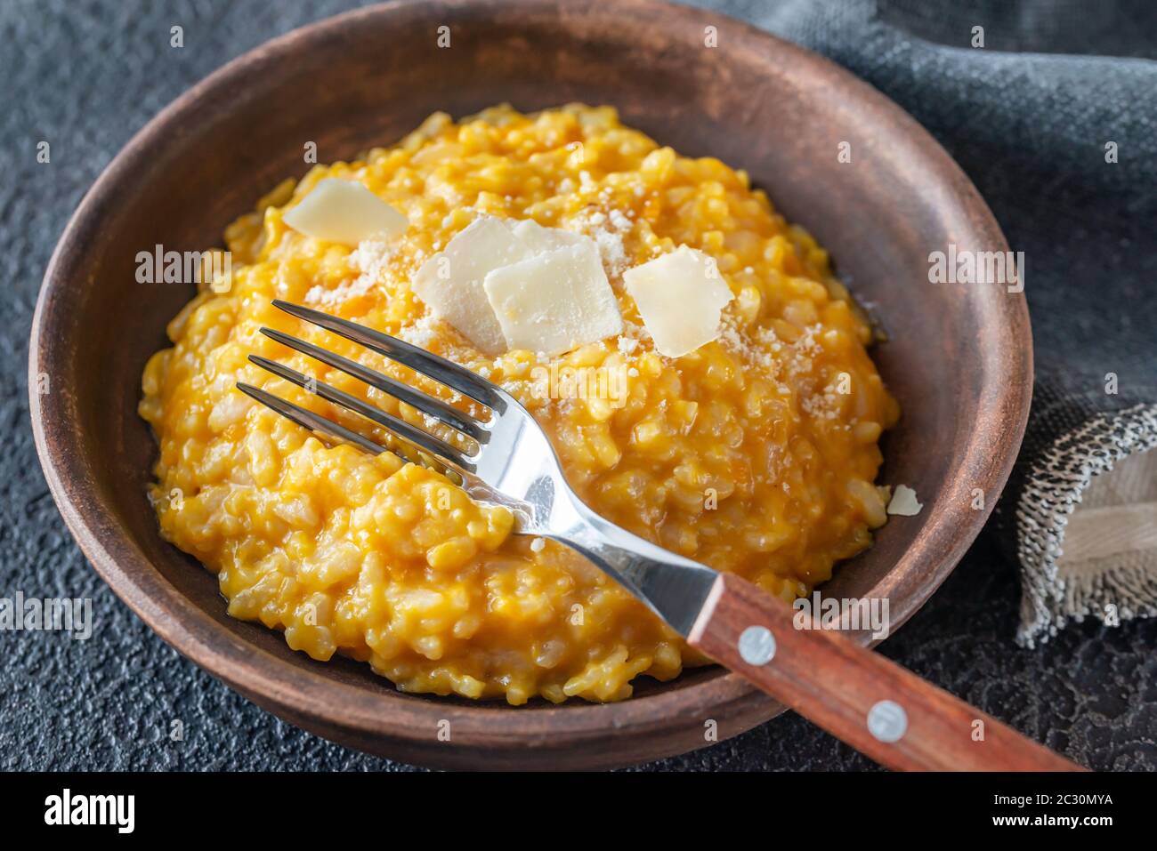 Portion of pumpkin risotto decorated witn slices of parmesan Stock ...
