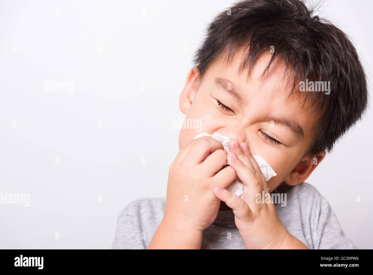 Closeup Asian face, Little children boy cleaning nose with tissue on ...