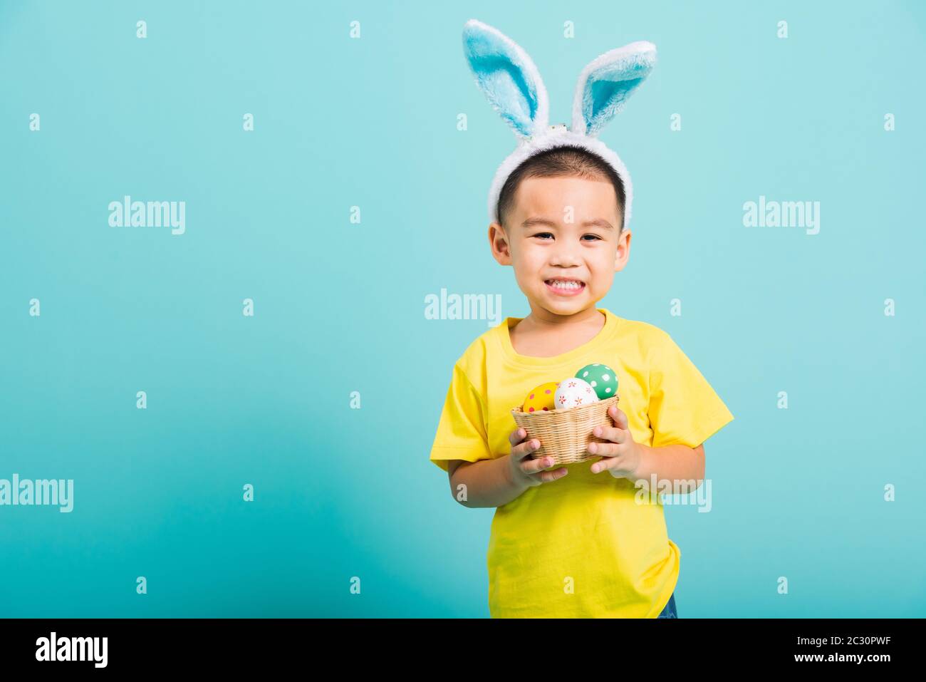 Asian cute little child boy smile beaming wearing bunny ears and a ...