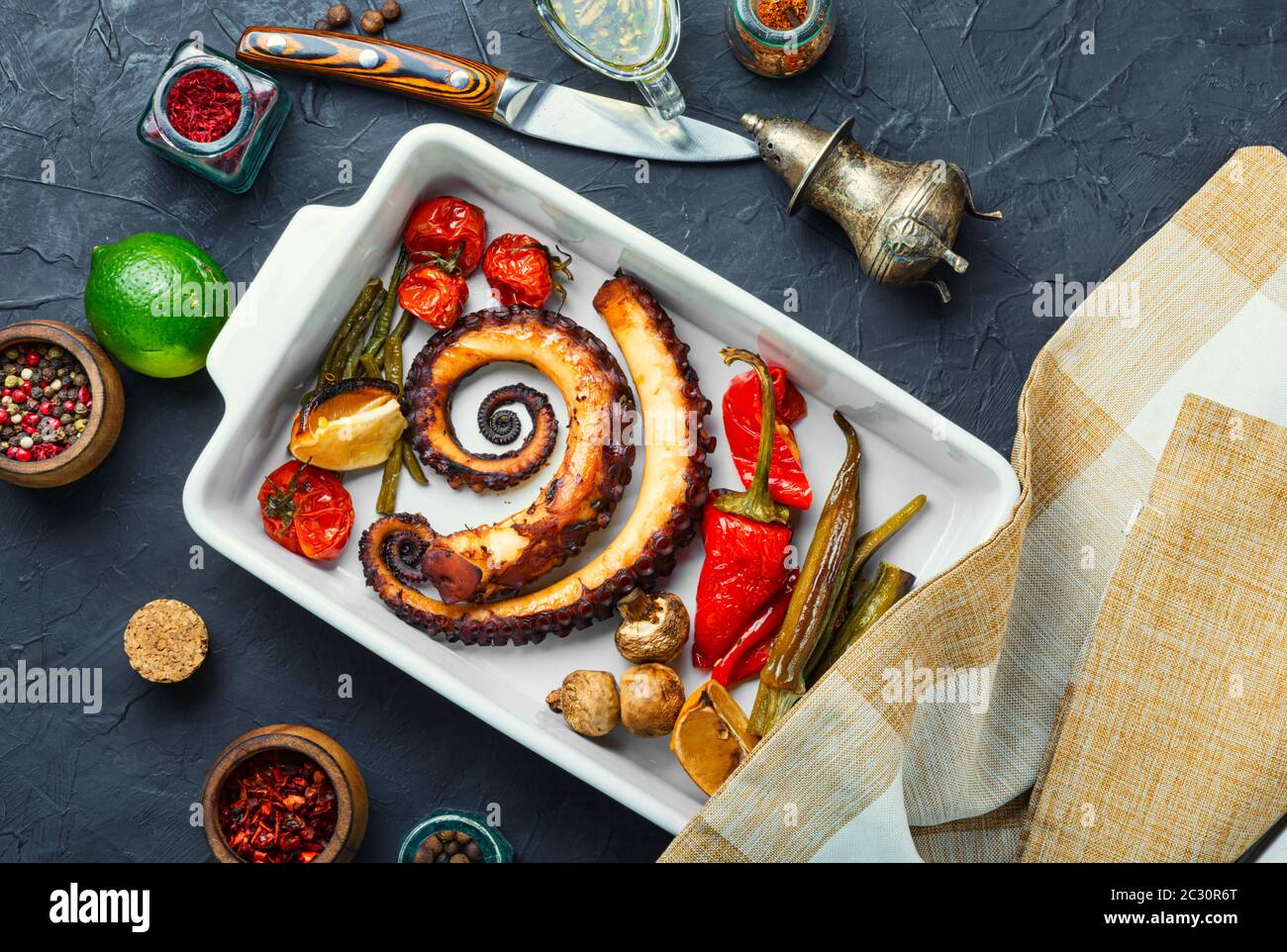 Grilled octopus with roasted vegetables in baking dish.Seafood Stock ...