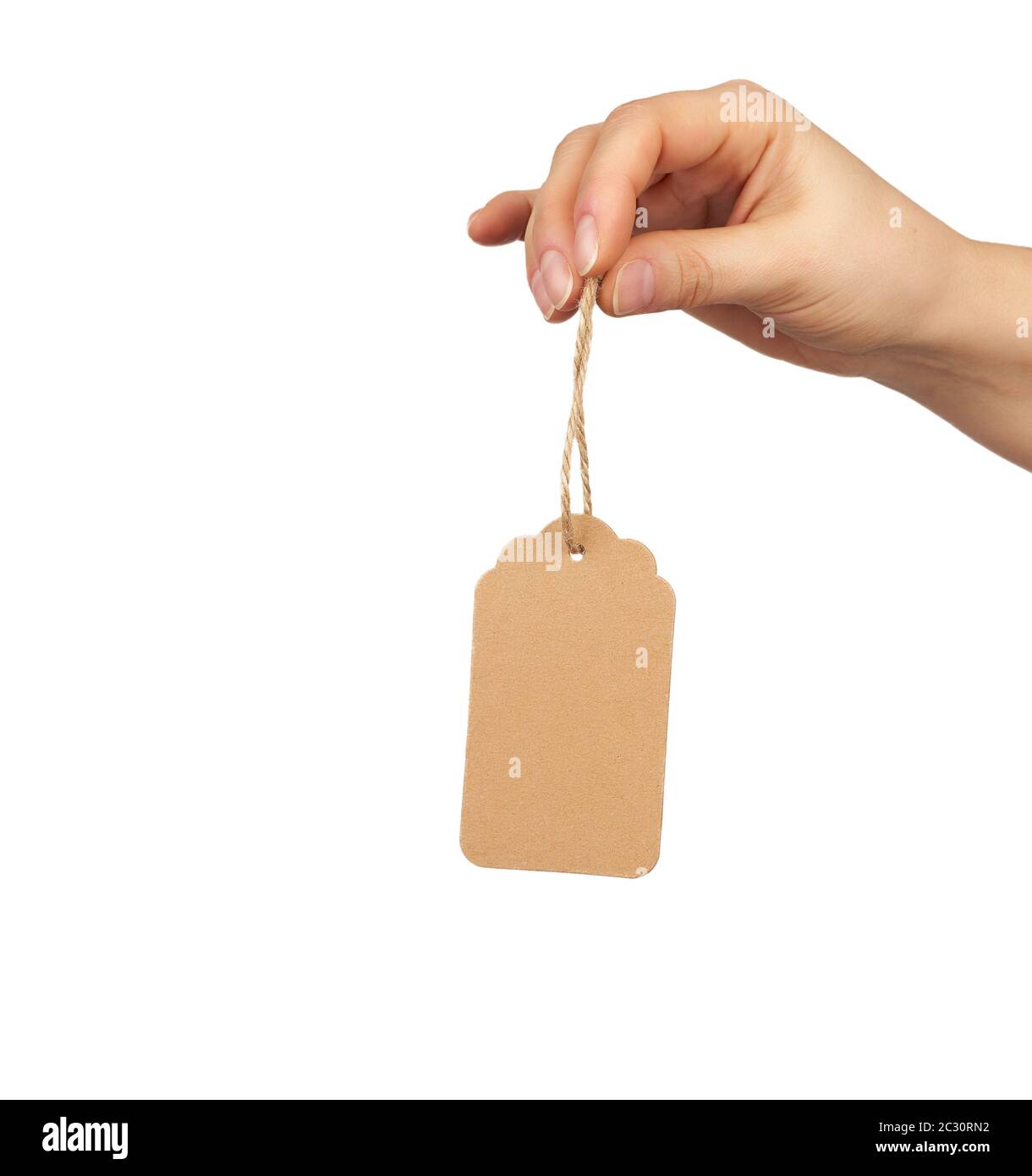 female hand holds a cardboard price tag from brown craft paper on a ...