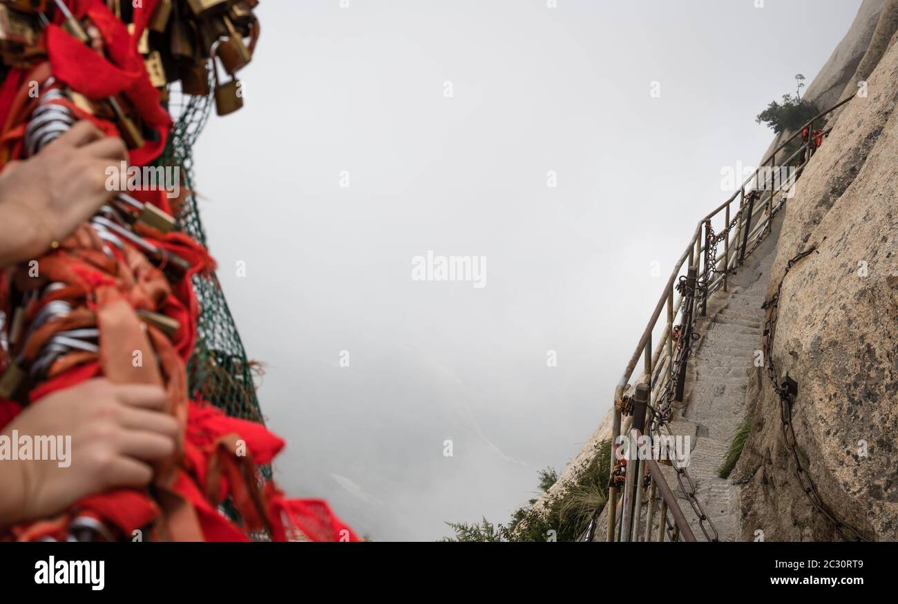 Stone steps cut on a side of a mountain rock leading to the dangerous ...
