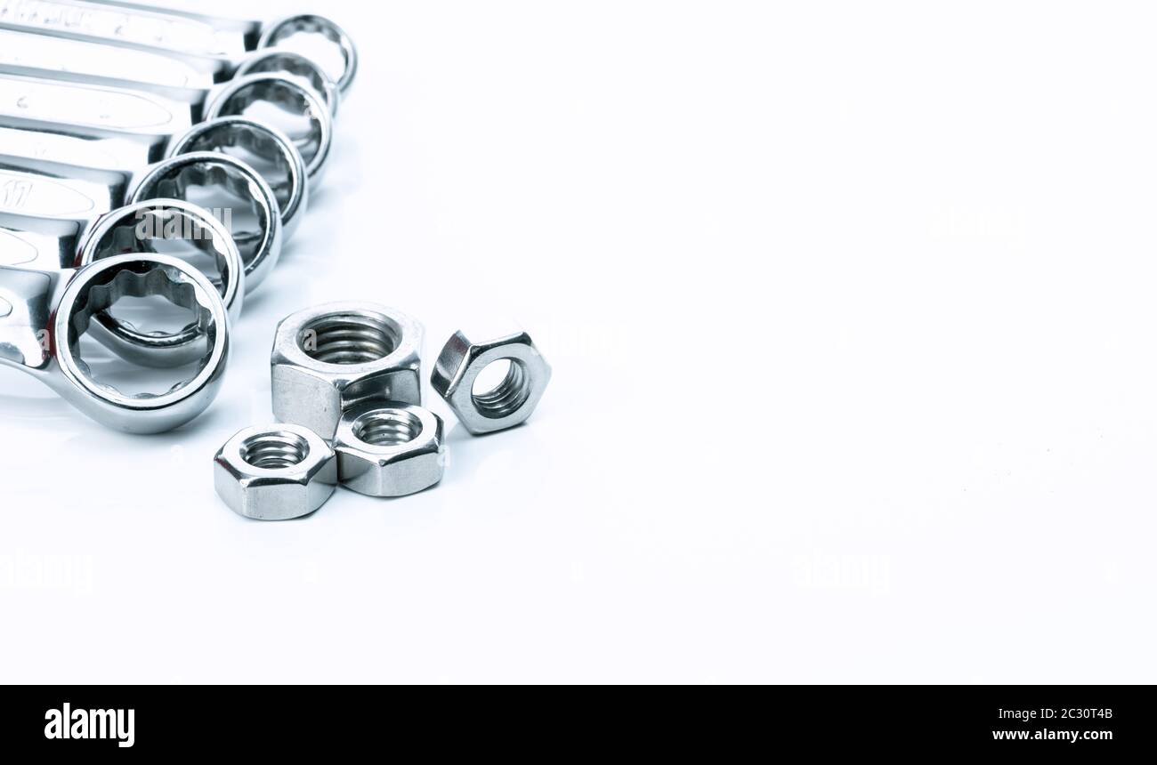 Metal hexagon nuts and chrome wrenches isolated on white background ...