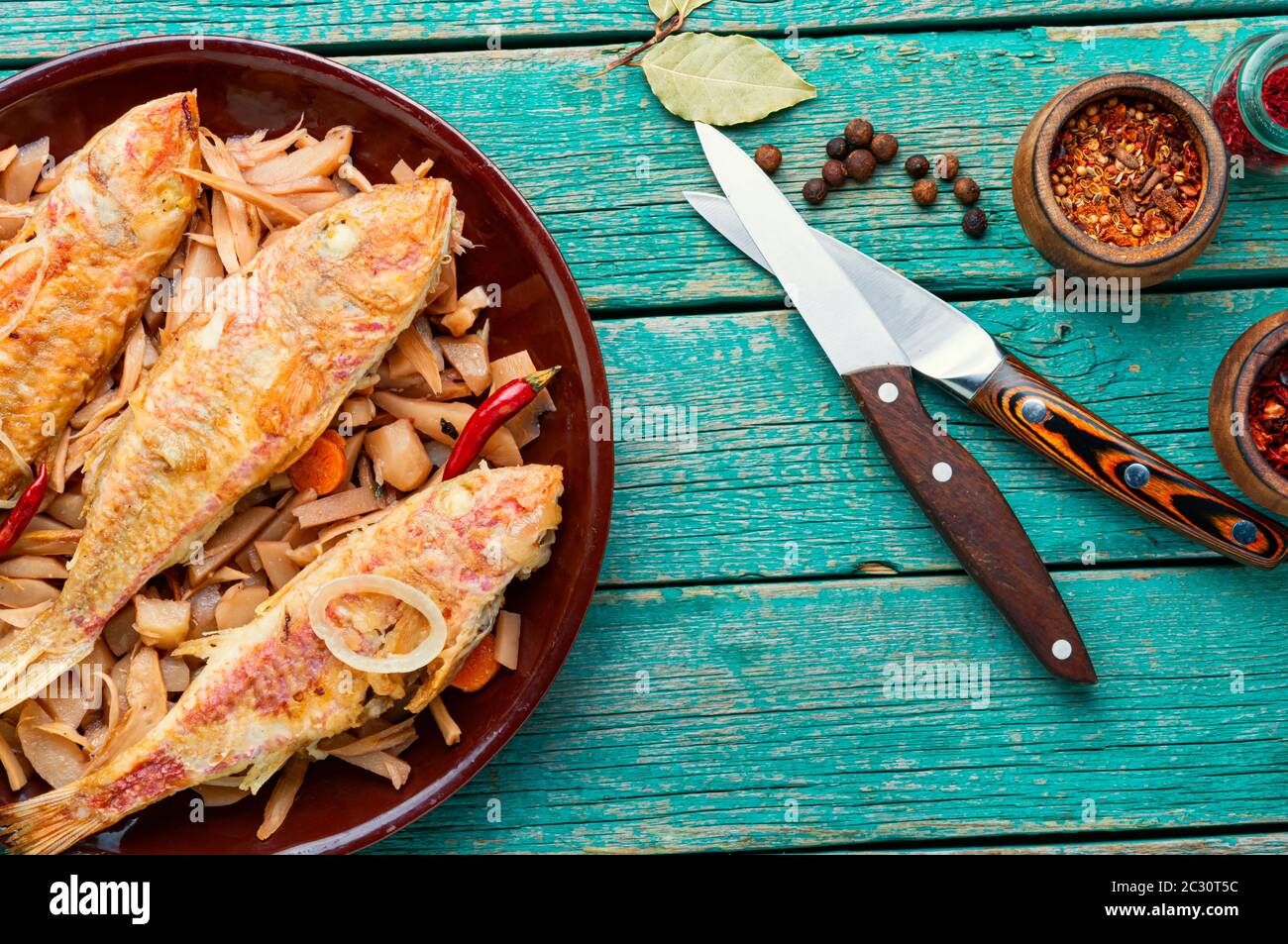 Spicy mullet fish fried with horseradish roots.Asian food Stock Photo ...
