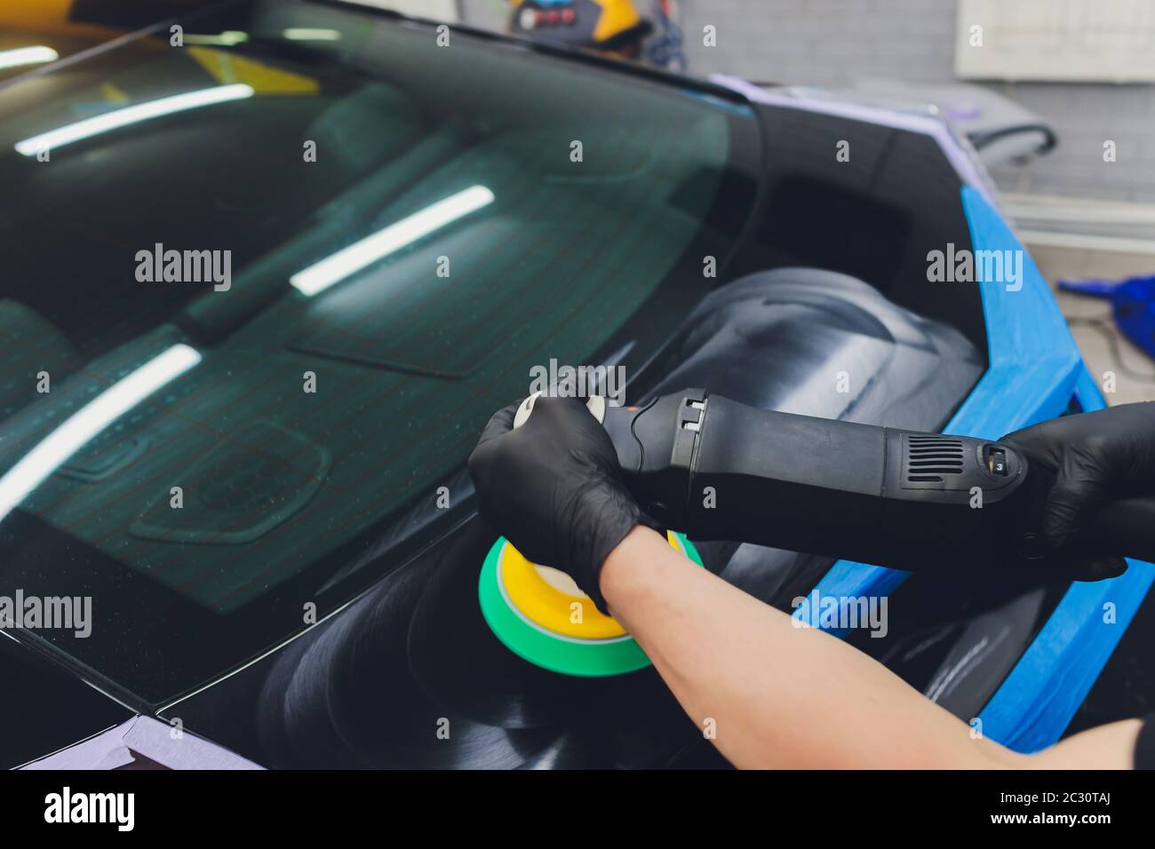Car detailing - Hands with orbital polisher in auto repair shop ...