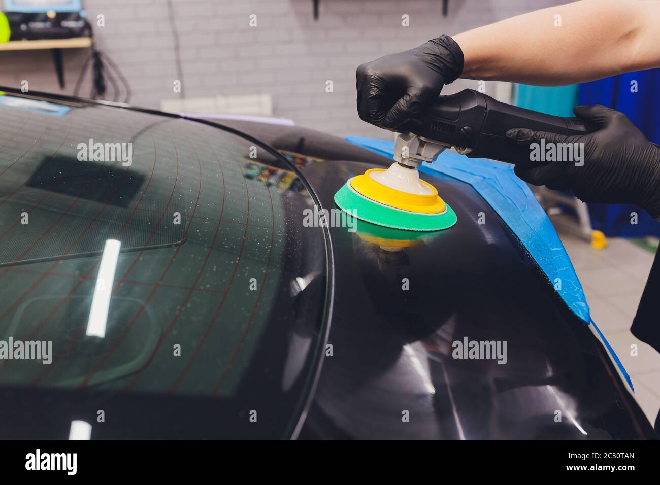 Car detailing - Hands with orbital polisher in auto repair shop ...