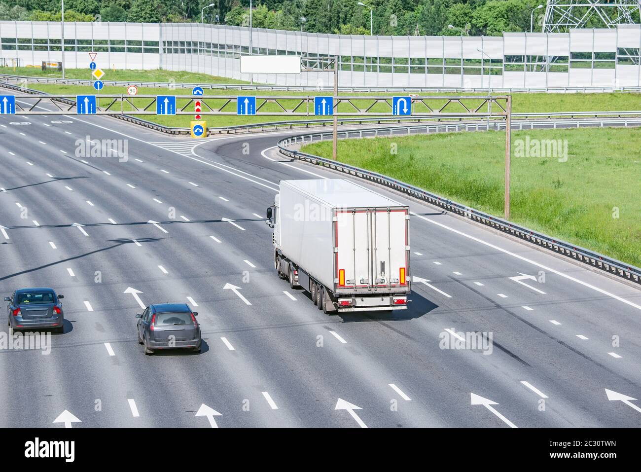 Freight truck and passenger cars move on the modern highway Stock Photo ...