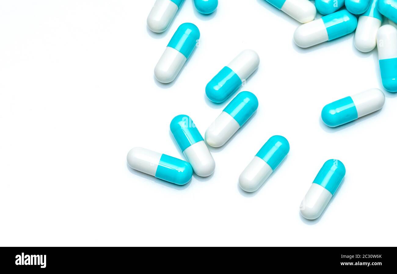 Blue-white capsule pills isolated on white background. Pharmaceutical ...