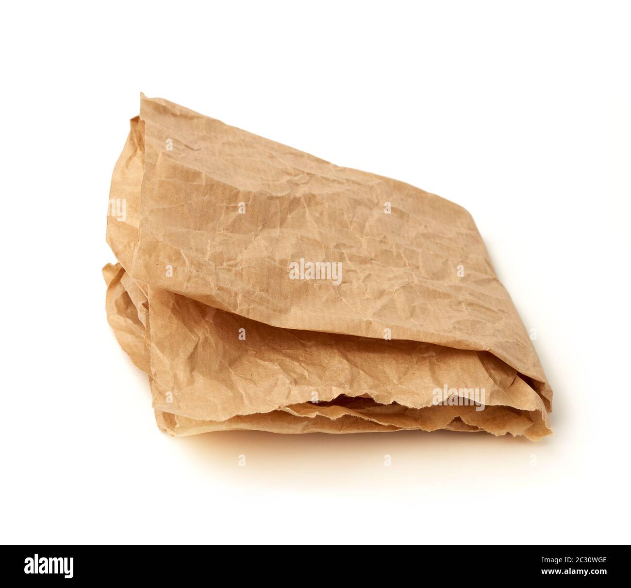 folded brown crumpled sheet of parchment paper isolated on white ...
