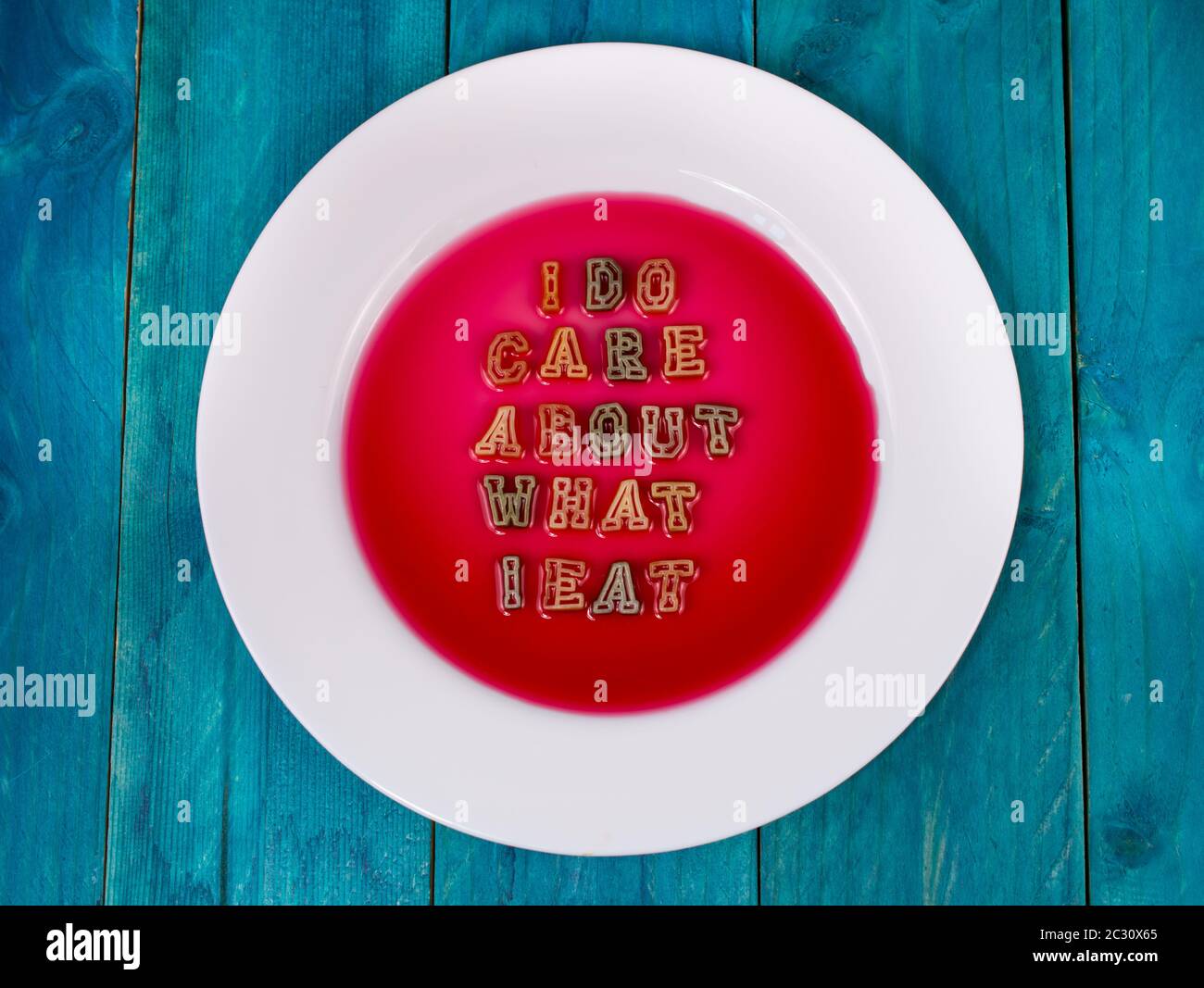 Healthy eating concept with alphabet pasta on white plate and blue ...