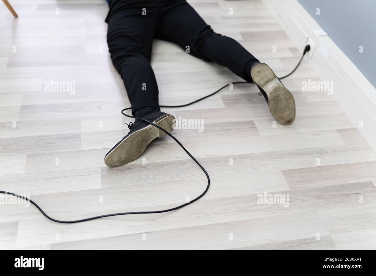 An Elevated View Of Man Stumbling With An Electrical Cord Stock Photo ...