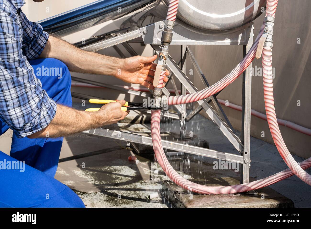 Man repairing leaking pipe hi-res stock photography and images - Alamy