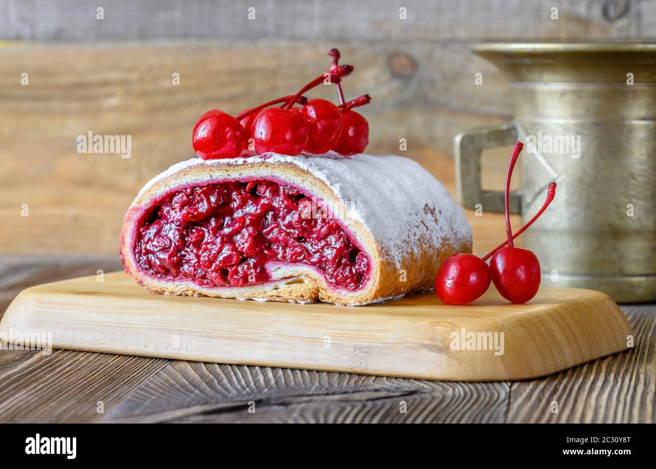 Strudel with cherry filling on wooden background Stock Photo - Alamy