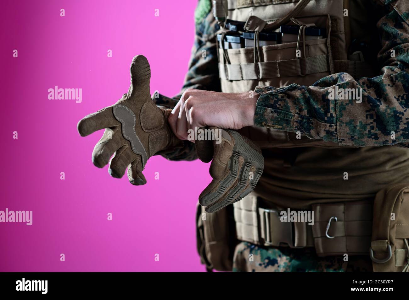 closeup of soldier hands putting protective battle gloves pink ...