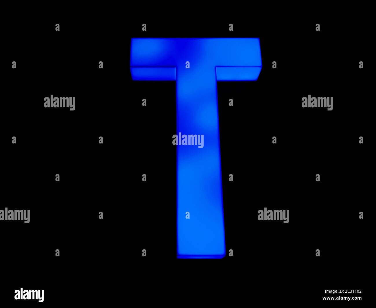 Blue neon light capital letter T over black background Stock Photo - Alamy